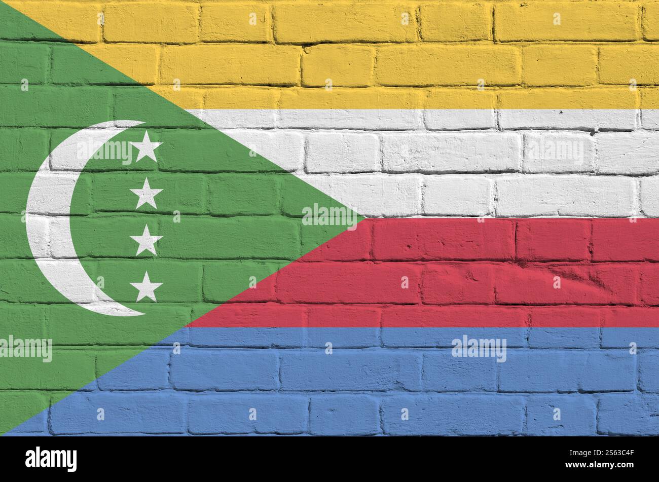 Comoros flag depicted in paint colors on old brick wall close up ...
