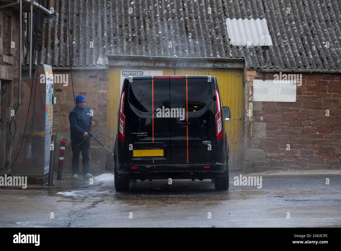 Jet washing a van at a filling station Stock Photo - Alamy