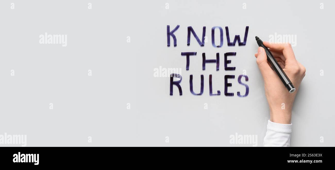 Woman's hand writing text KNOW THE RULES on light background. Banner ...