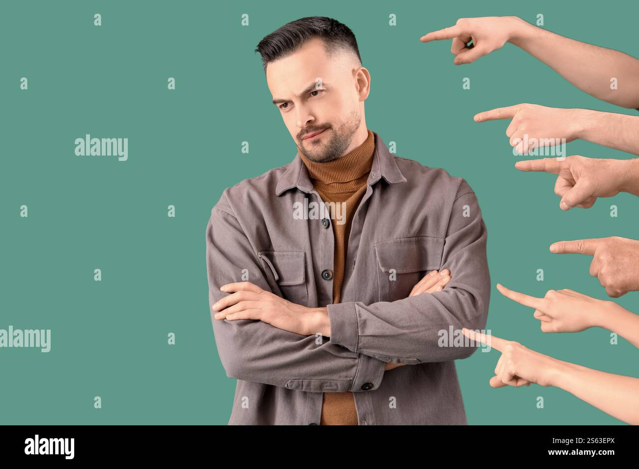 People pointing at young man on green background. Accusation concept ...