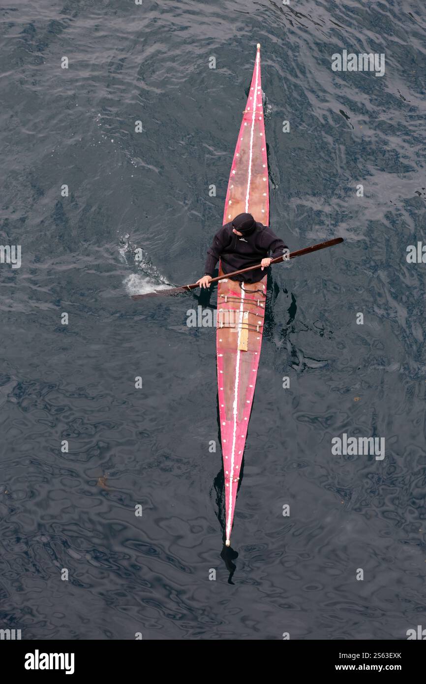 An Inuit man showing his Kayaking skills on a animal skin covered ...