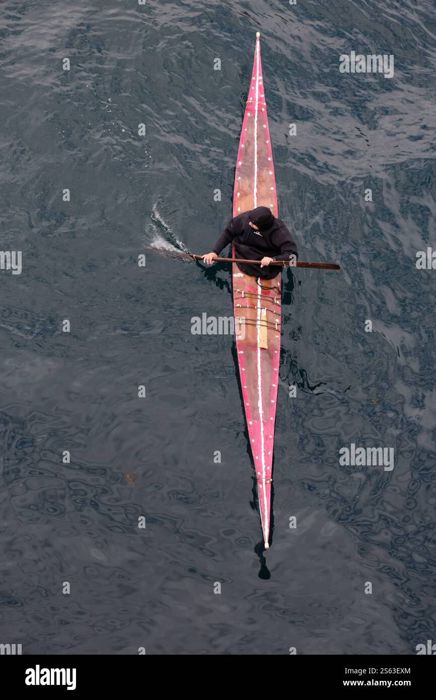 An Inuit man showing his Kayaking skills on a animal skin covered ...