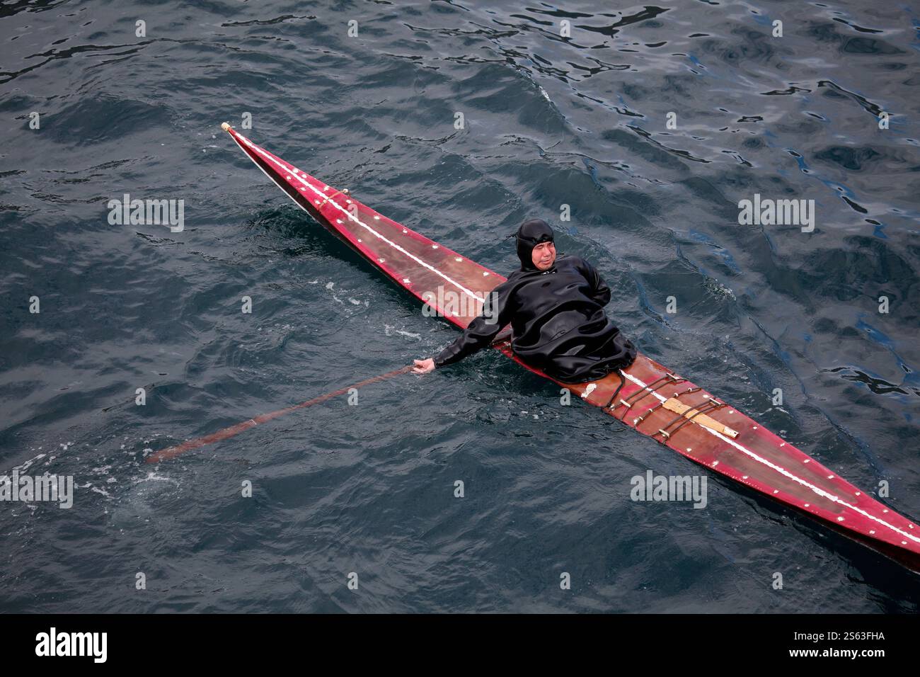 An Inuit man showing his Kayaking skills on a animal skin covered ...