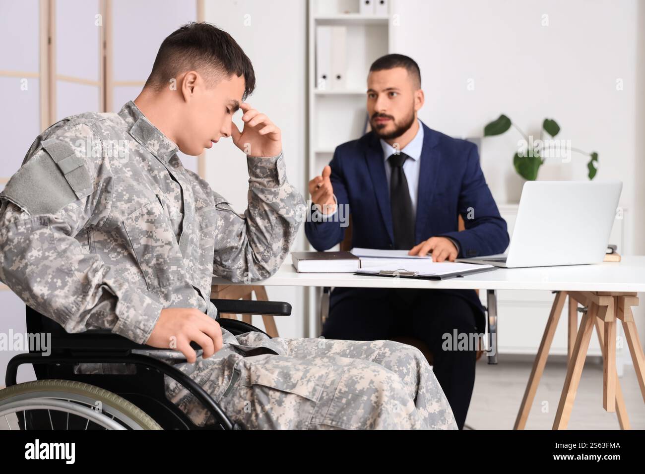 Sad soldier in wheelchair at lawyer's office Stock Photo - Alamy