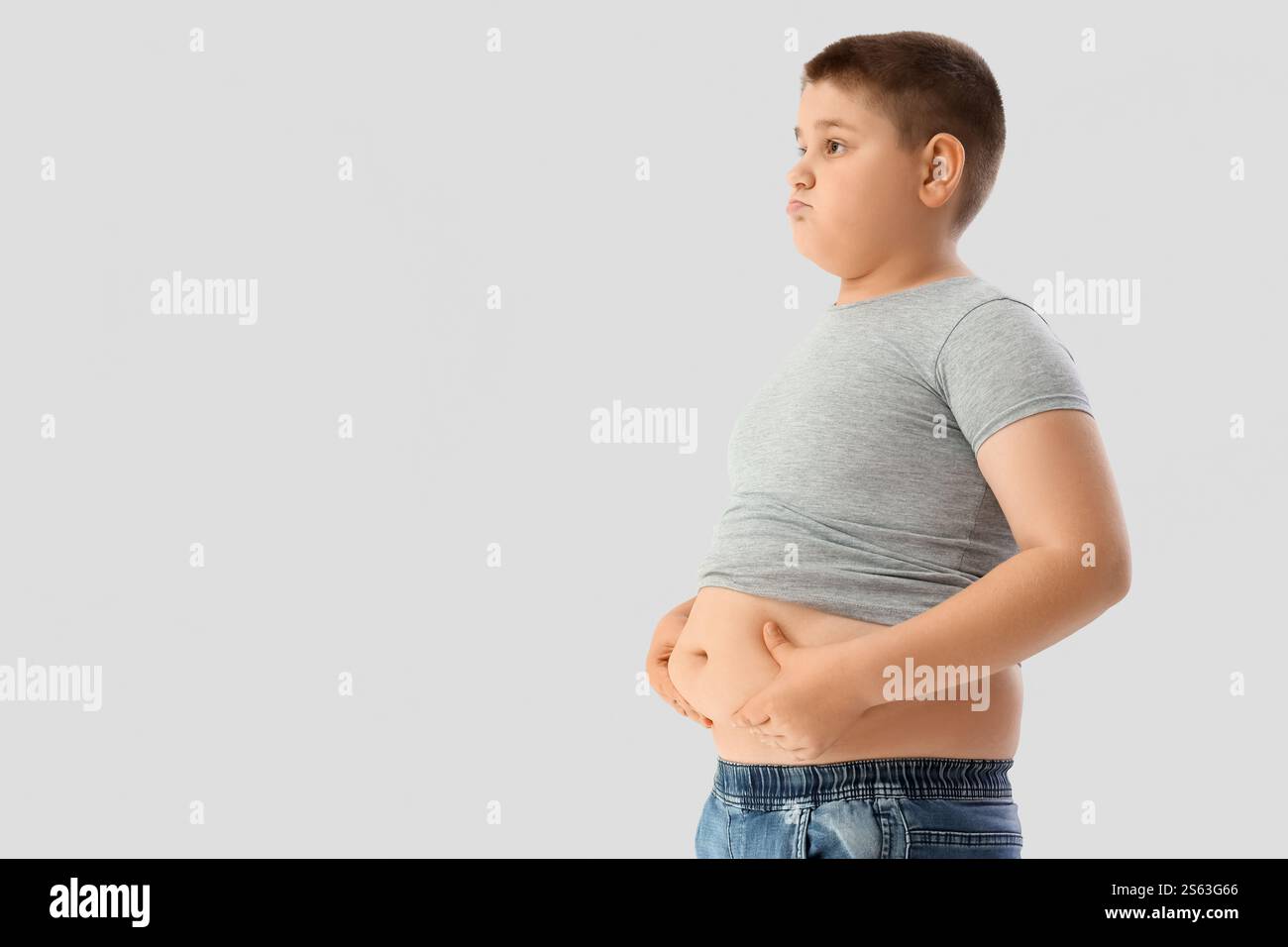 Overweight boy with big belly on light background. Diet concept Stock ...