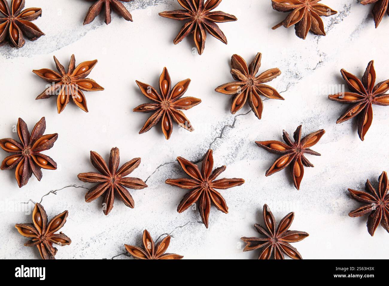 Texture of anise stars on white background Stock Photo - Alamy