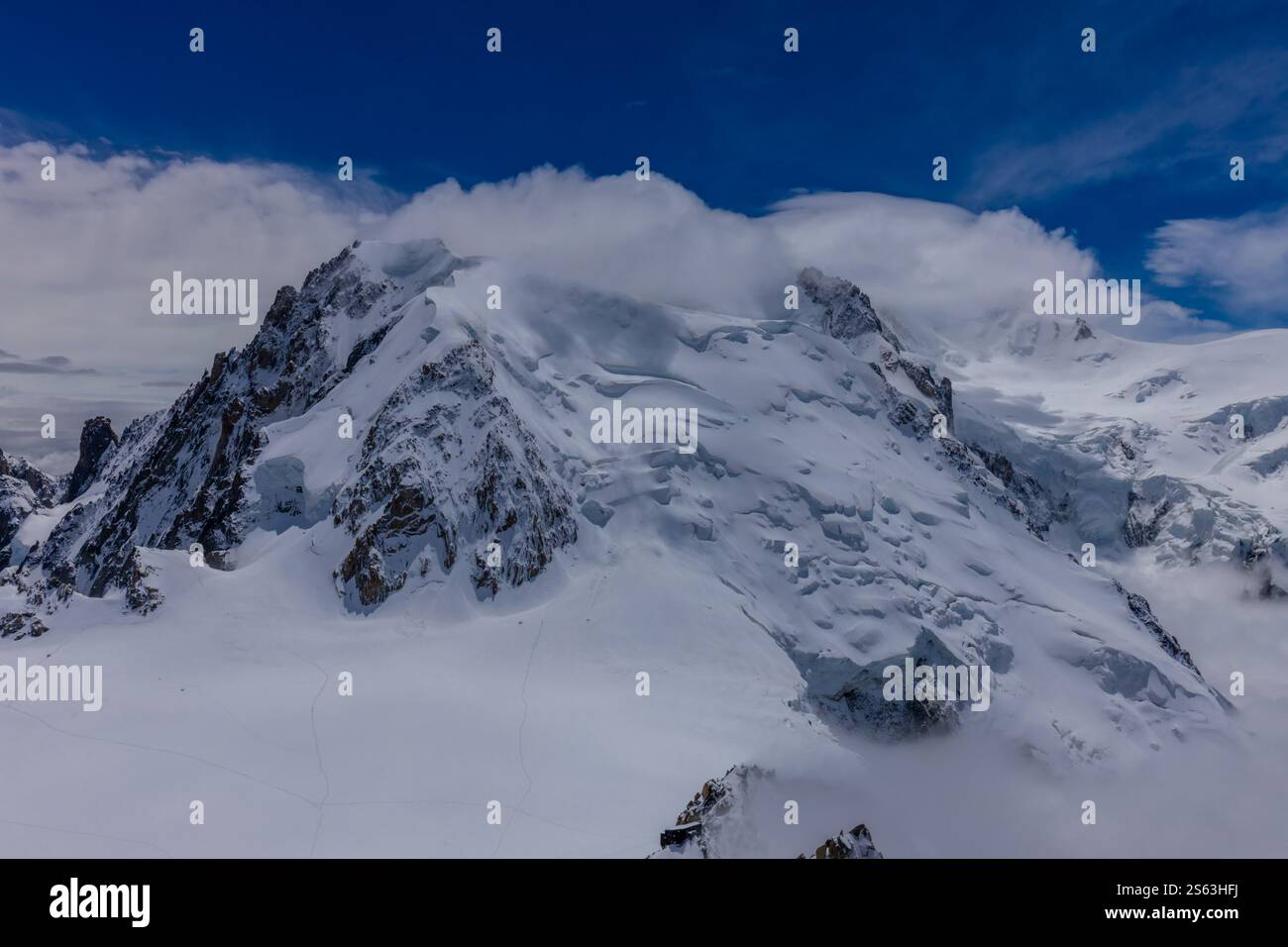 Snow mountain summits and white ice glacier in the Alps. Mont Blanc climbing route and views ...