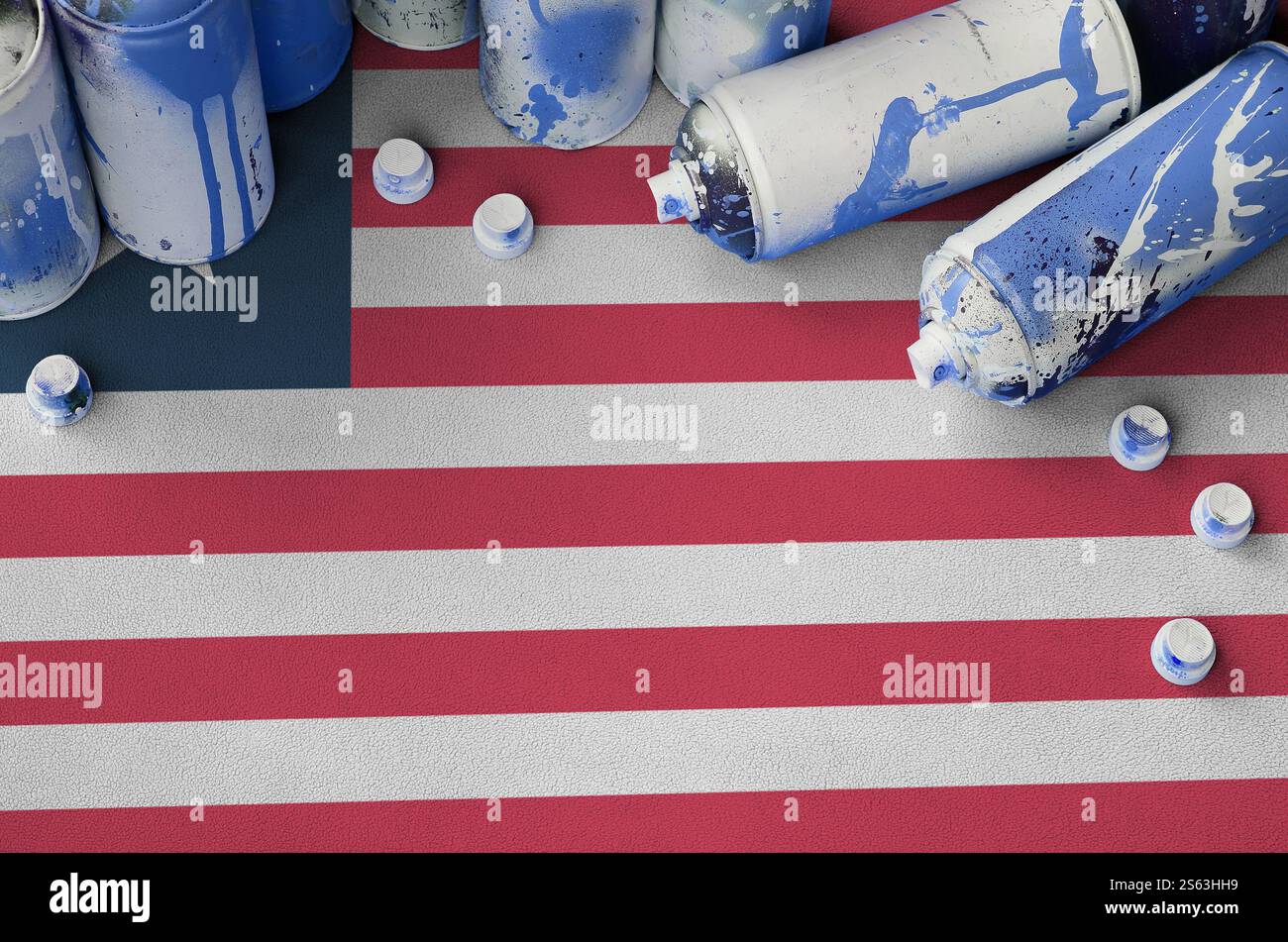 Liberia flag and few used aerosol spray cans for graffiti painting ...