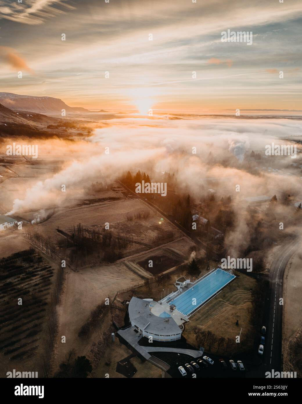 Aerial view of a swimming pool surrounded by geothermal steam in ...