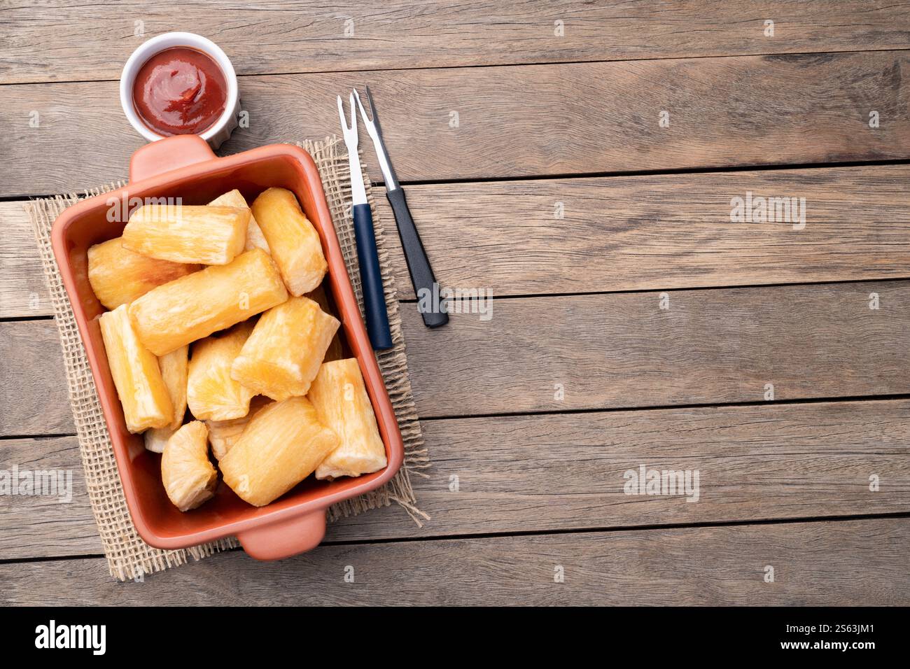 Traditional brazilian fried manioc in a plate over wooden table with ...