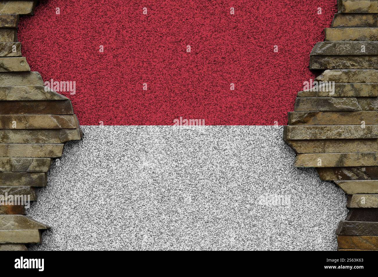 Monaco flag depicted in paint colors on old stone wall close up ...