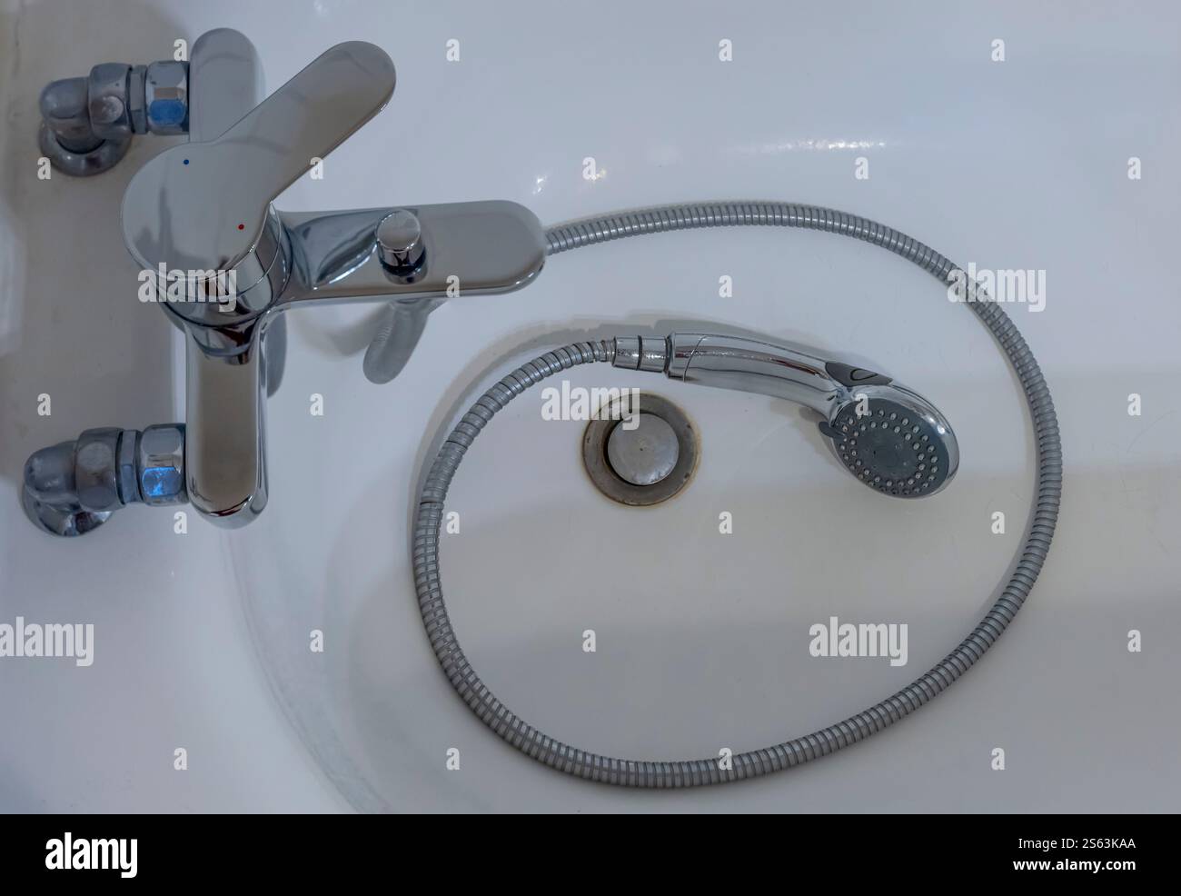 Paris, France - 01 12 2025: Shower hose placed at the bottom of the ...