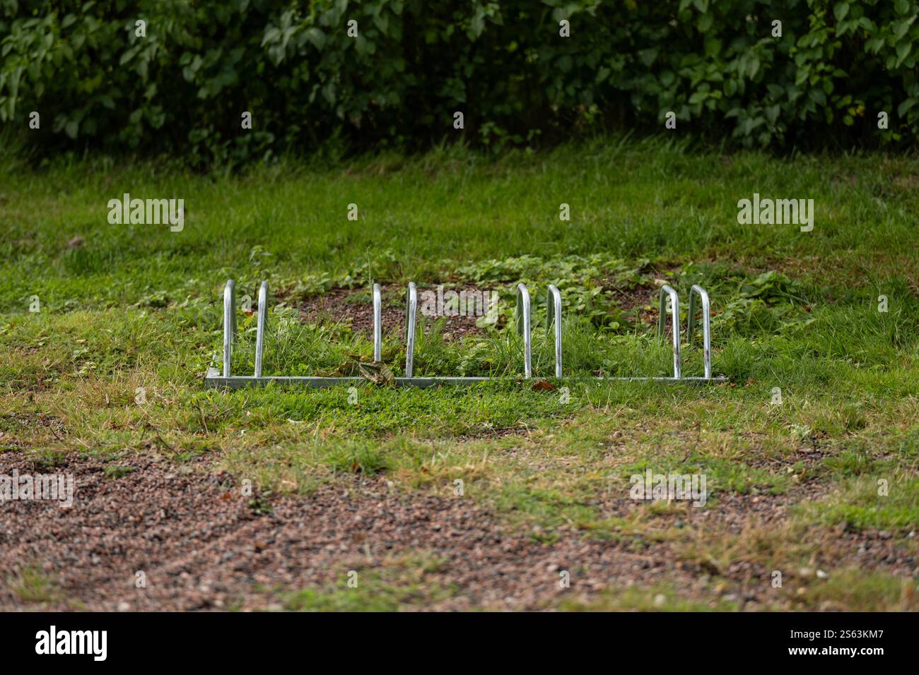 Metal bicycle parking rack in grass field Stock Photo - Alamy