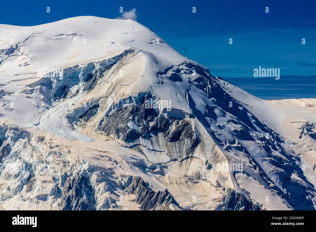 Snow mountain summits and white ice glacier in the Alps. Mont Blanc climbing route and views ...