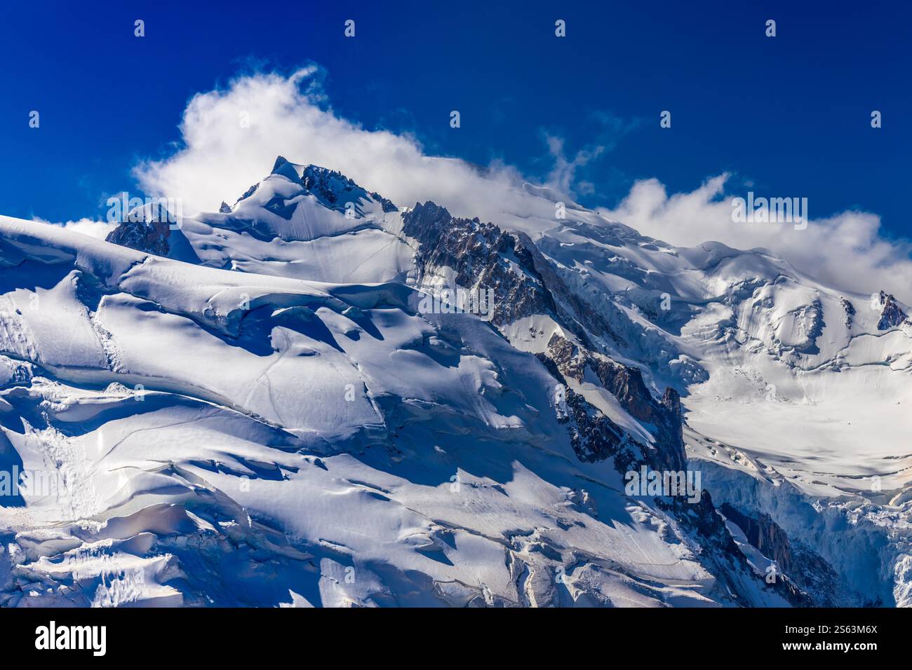 Snow mountain summits and white ice glacier in the Alps. Mont Blanc climbing route and views ...