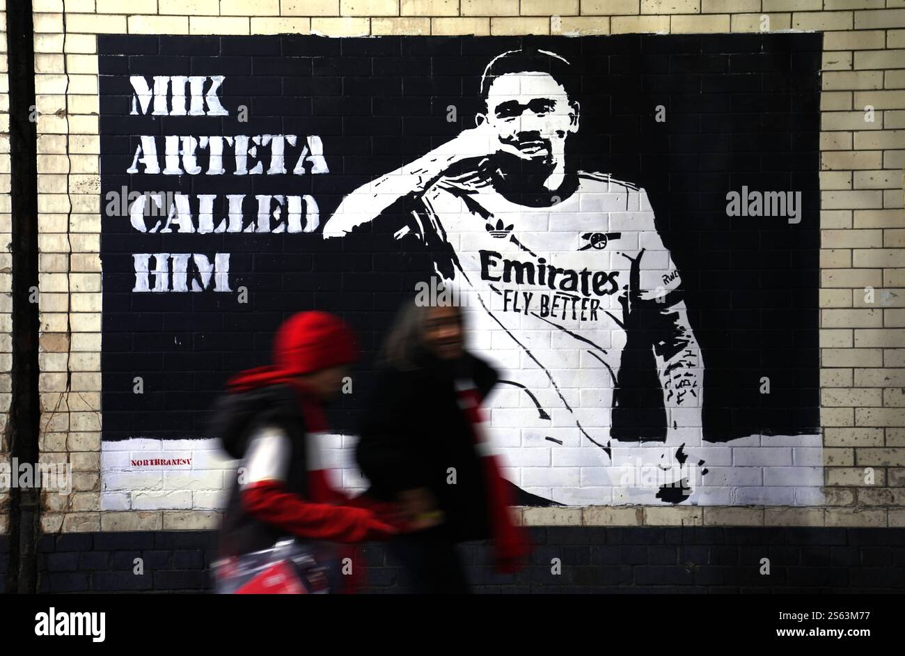 A mural of Arsenal's Gabriel Jesus by artist 'Northbanksy' as fans walk ...