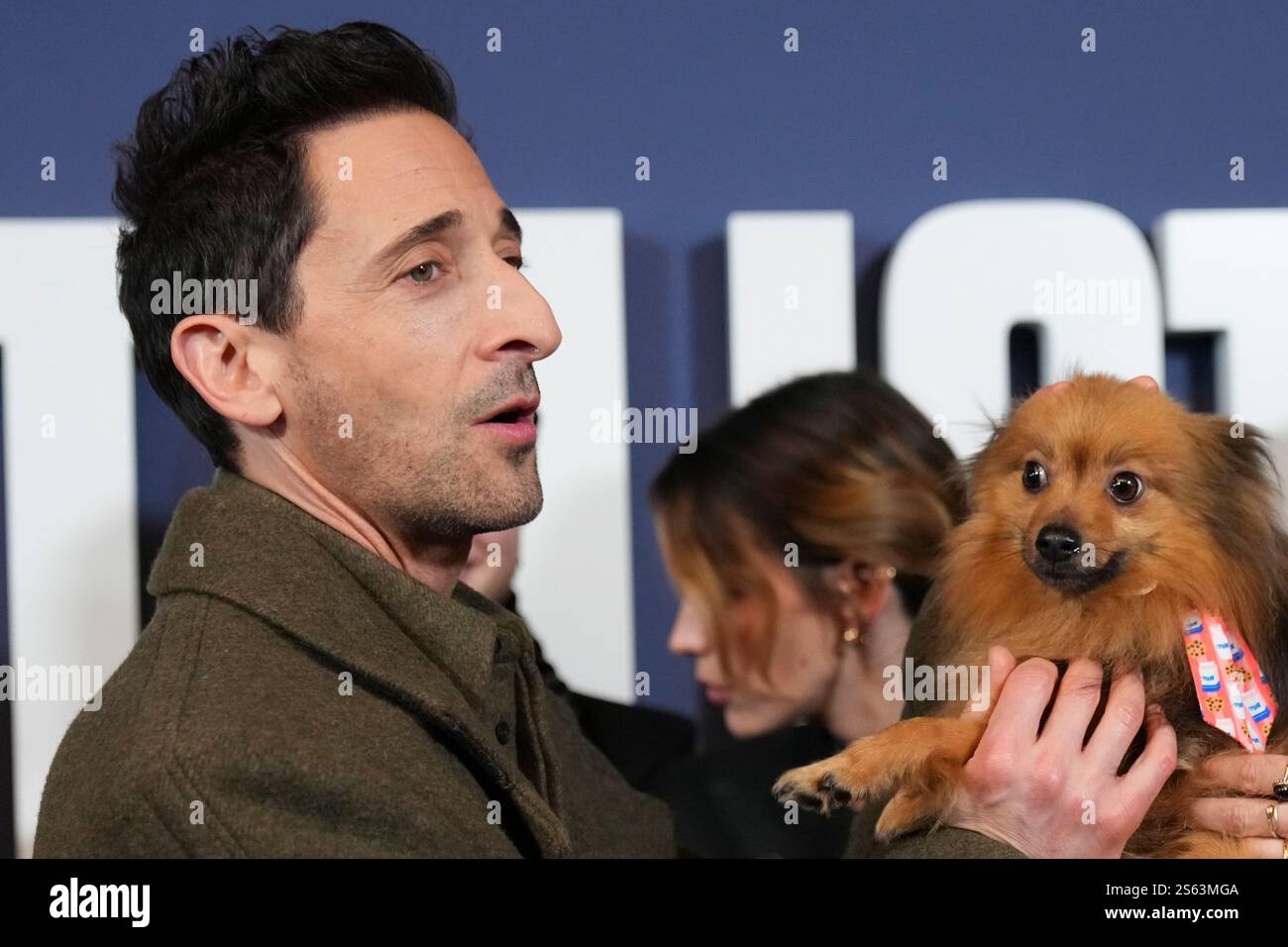 Adrien Brody greets Arlo the dog upon arrival for the premiere of the ...