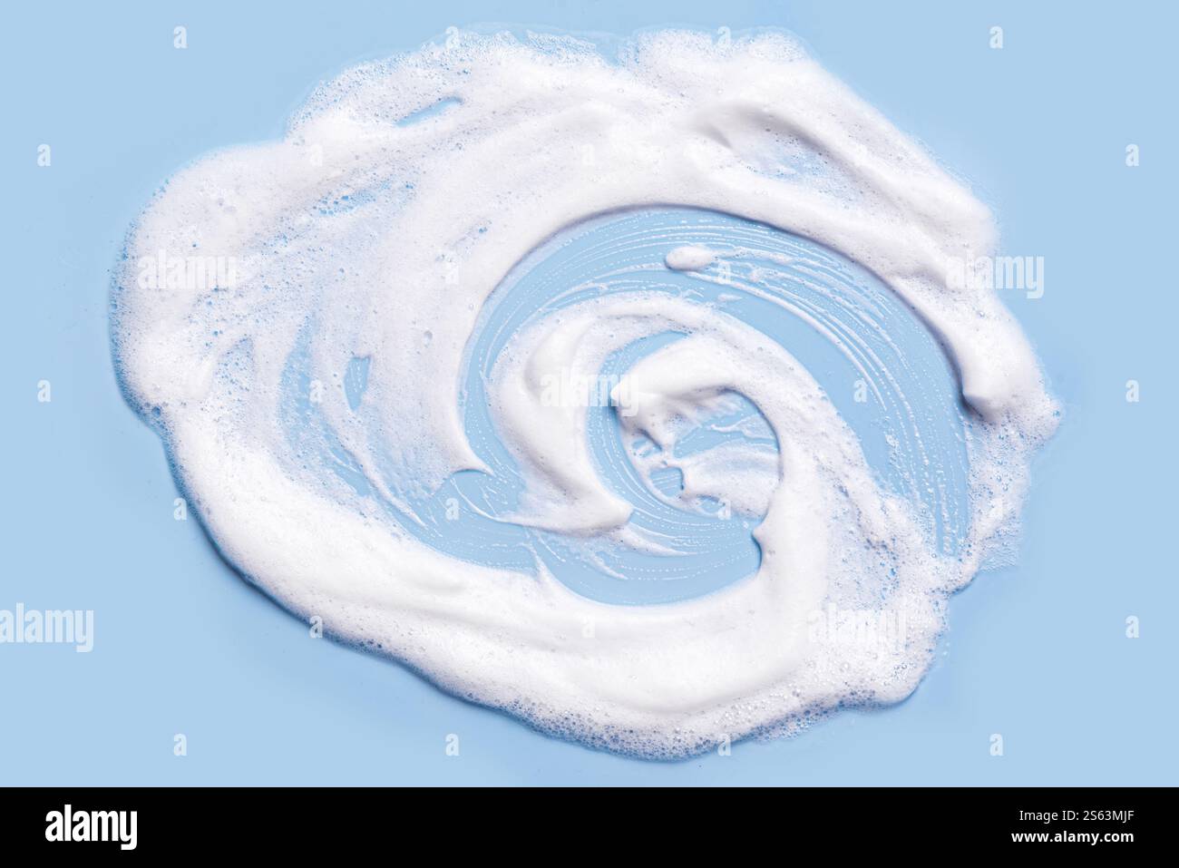 White soft foam texture sample on blue pastel background. Face cleanser ...