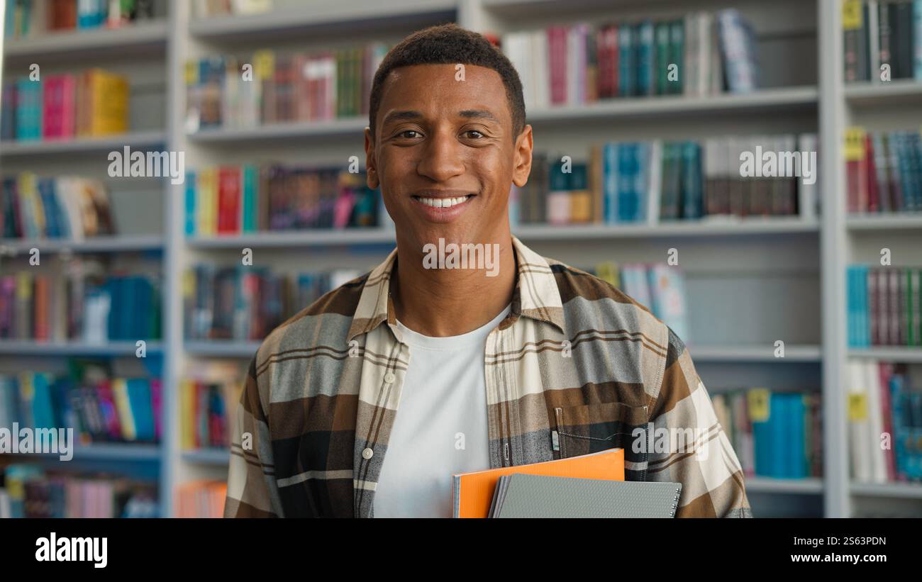 Successful happy African American man student male library textbooks ...