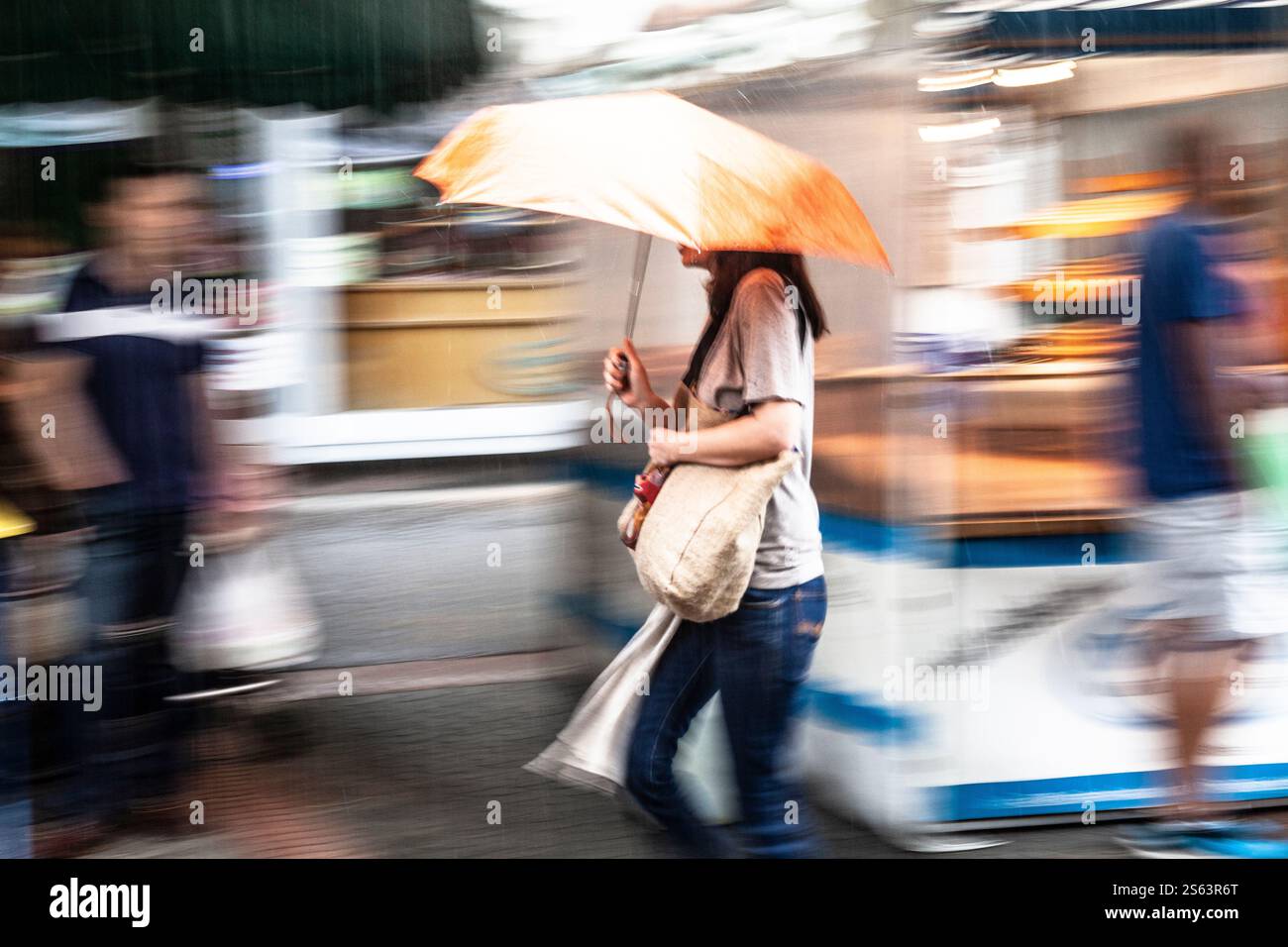 Woman getting wet in rain hi-res stock photography and images - Alamy