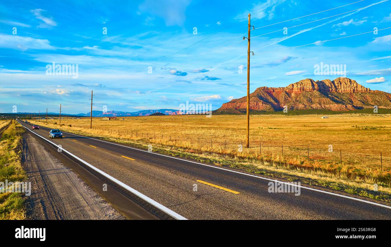 Aerial of Highway Through Red Rock Formations in Utah at Golden Hour ...