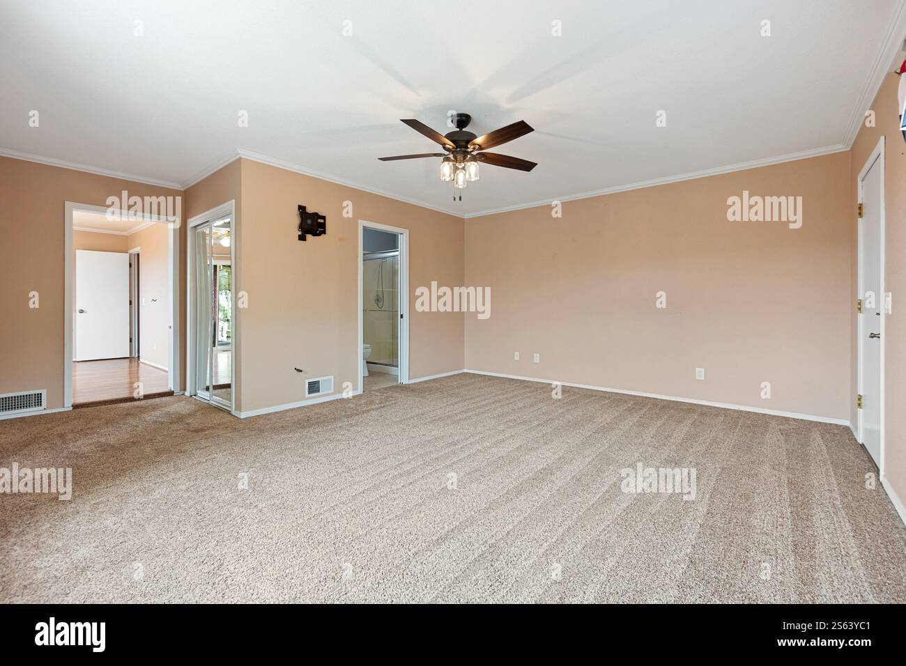 Light-filled living area features elegant wooden flooring and high ...