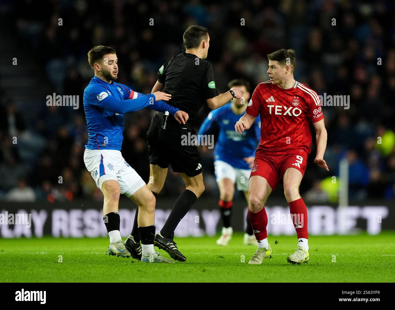 Rangers' Nicolas Raskin (left) collides with the referee during the ...