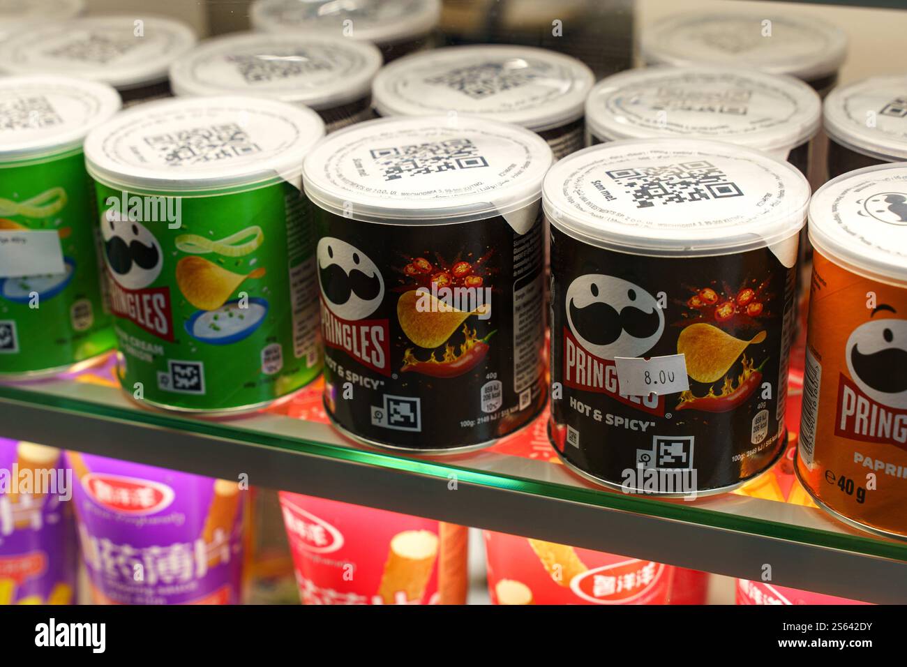 Minsk, Belarus - August 16, 2024: Brightly colored snack cans line the ...