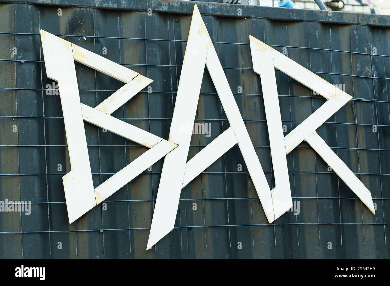 Eye-catching wooden letters spell out bar in a trendy outdoor setting ...