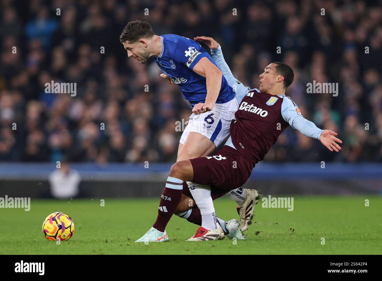 Liverpool, UK. 15th Jan, 2025. James Tarkowski of Everton is tackled by ...