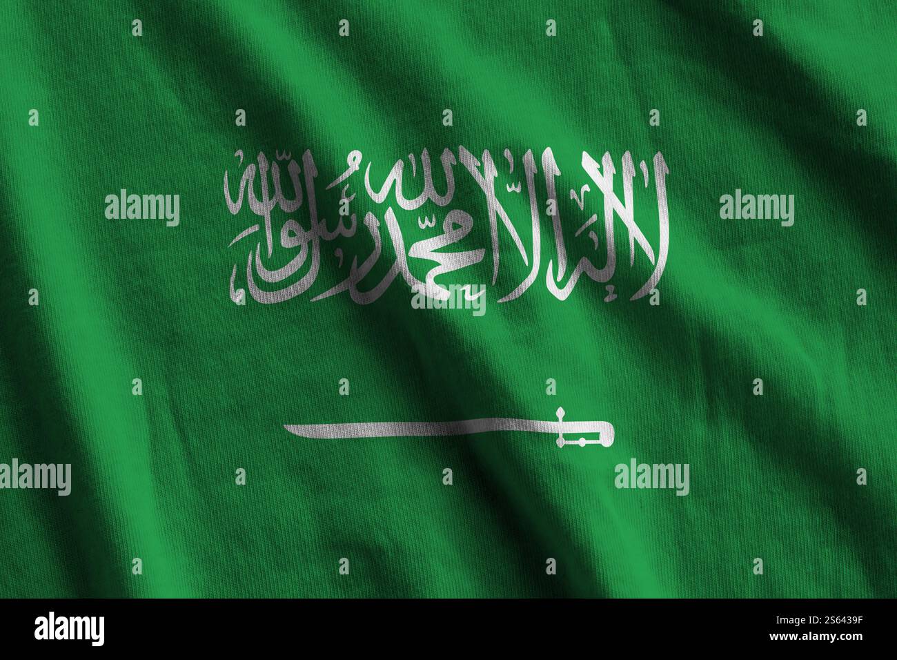 Saudi Arabia flag with big folds waving close up under the studio light ...