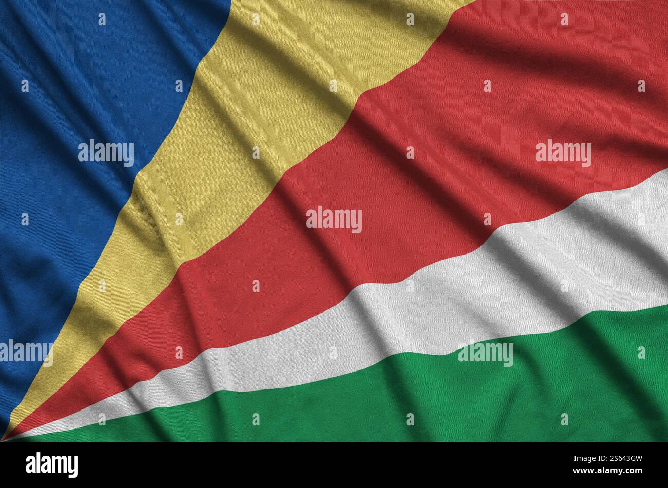 Seychelles flag is depicted on a sports cloth fabric with many folds ...