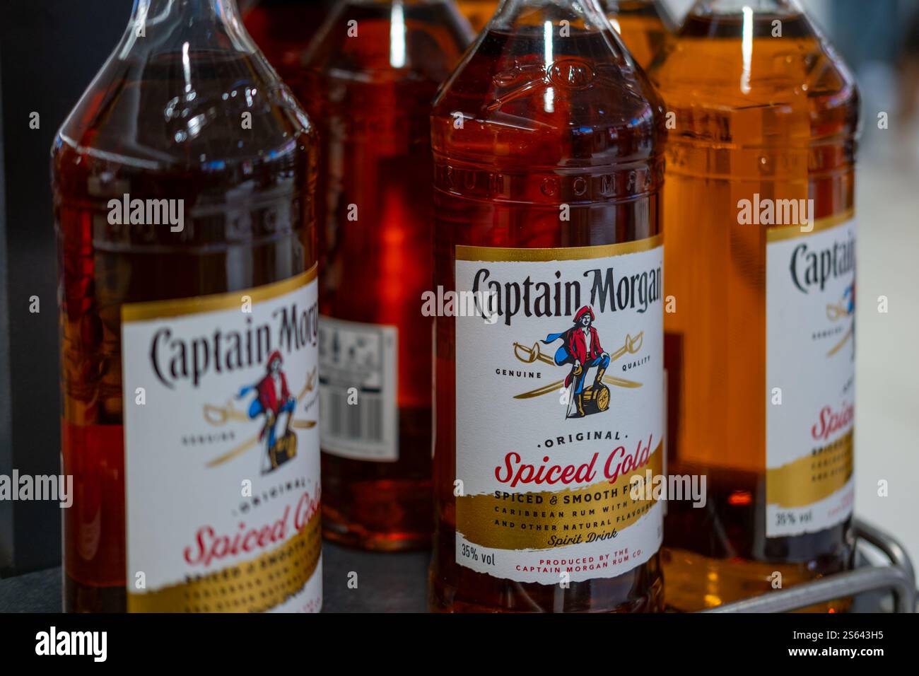 row Captain Morgan Spiced Gold rum bottles on store shelf, showcasing ...