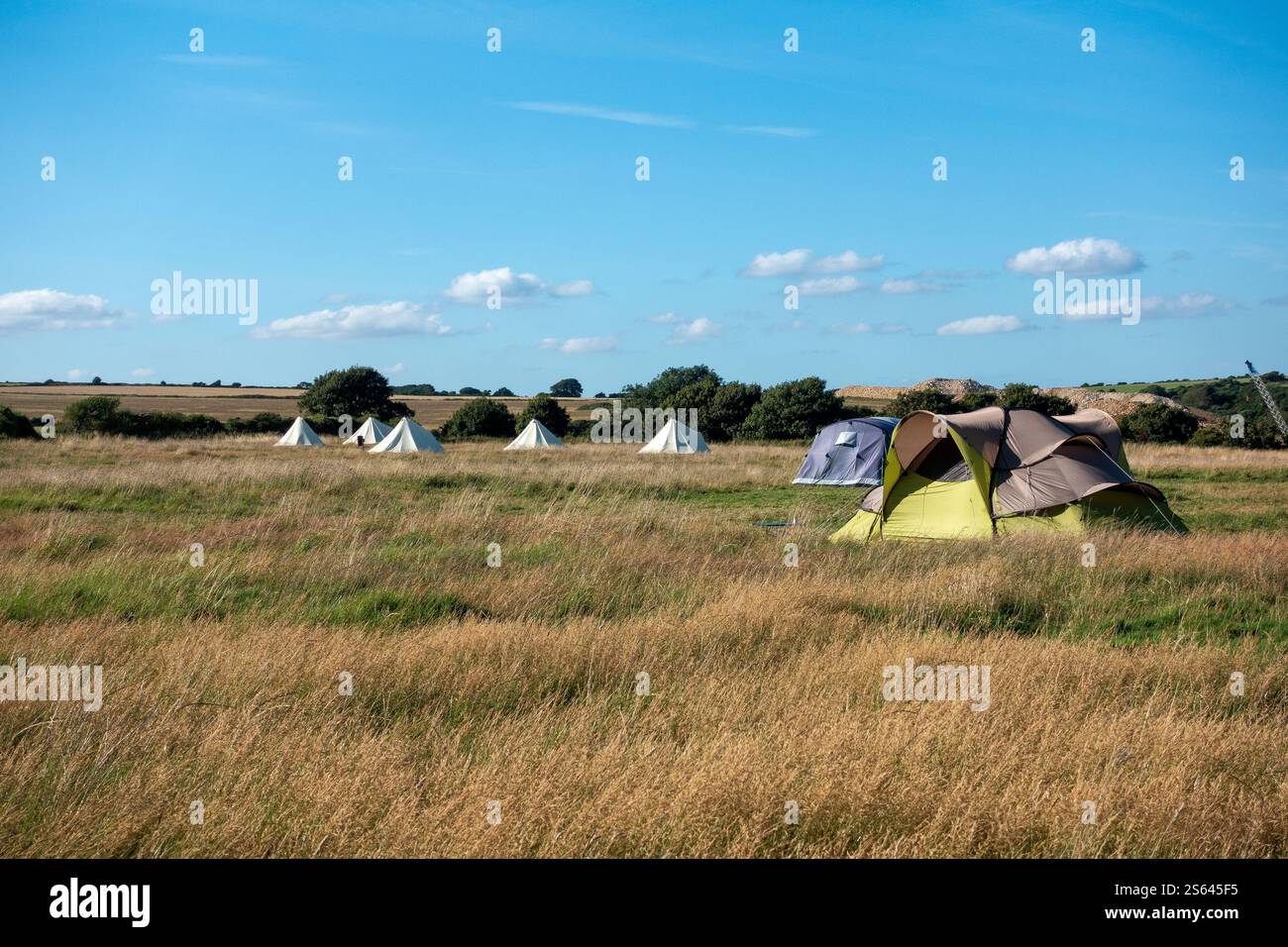 A group of colorful tents is set up in an open field at the Weston ...