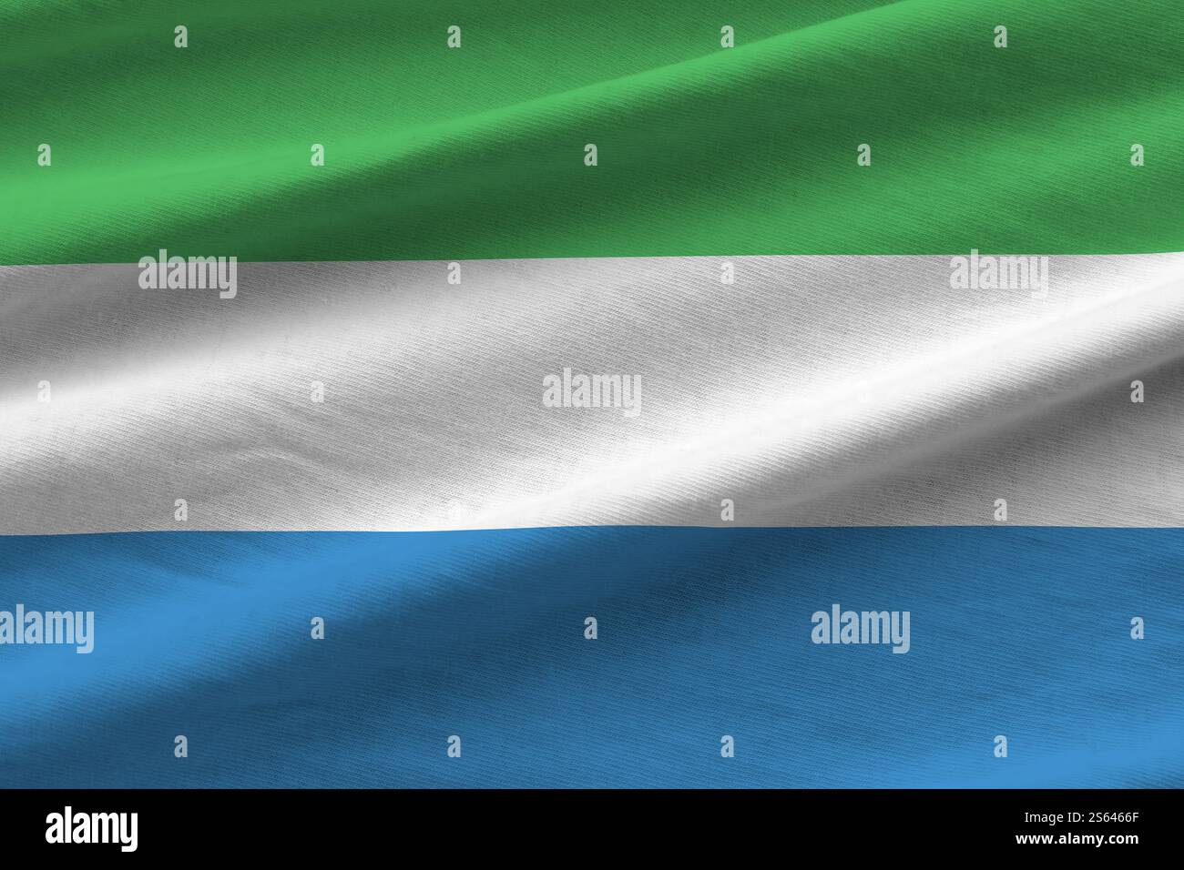 Sierra Leone flag with big folds waving close up under the studio light ...