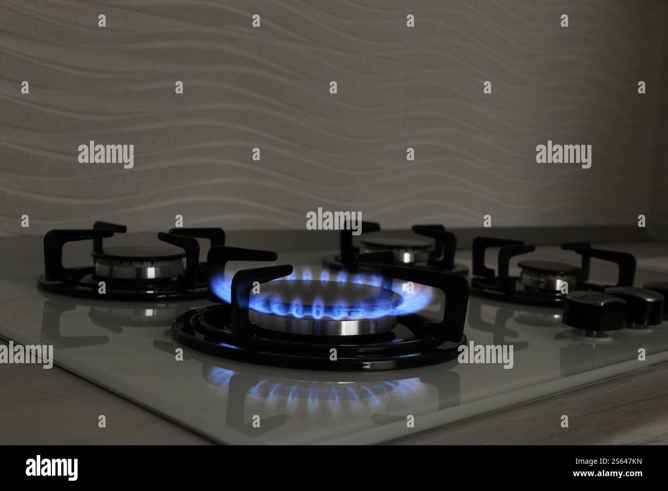 Modern gas cooktop with burning blue flame in kitchen Stock Photo - Alamy