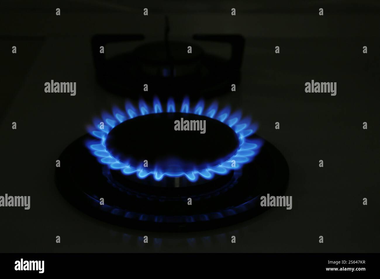 Modern gas cooktop with burning blue flame in kitchen at night Stock ...