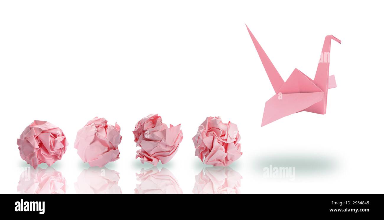 Pink origami crane and crumpled paper balls on white background, banner ...