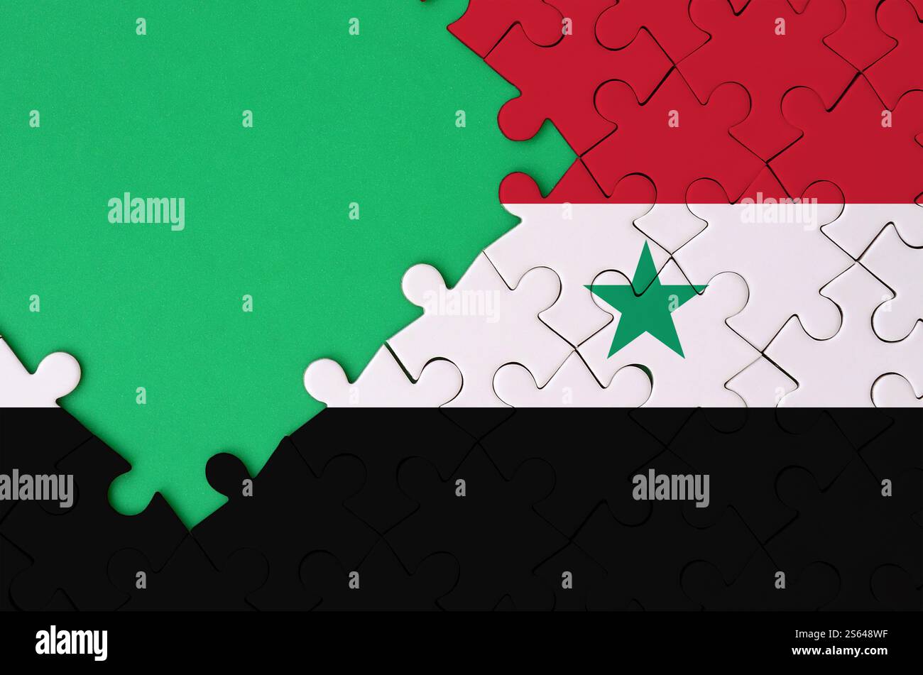 Syria flag is depicted on a completed jigsaw puzzle with free green ...