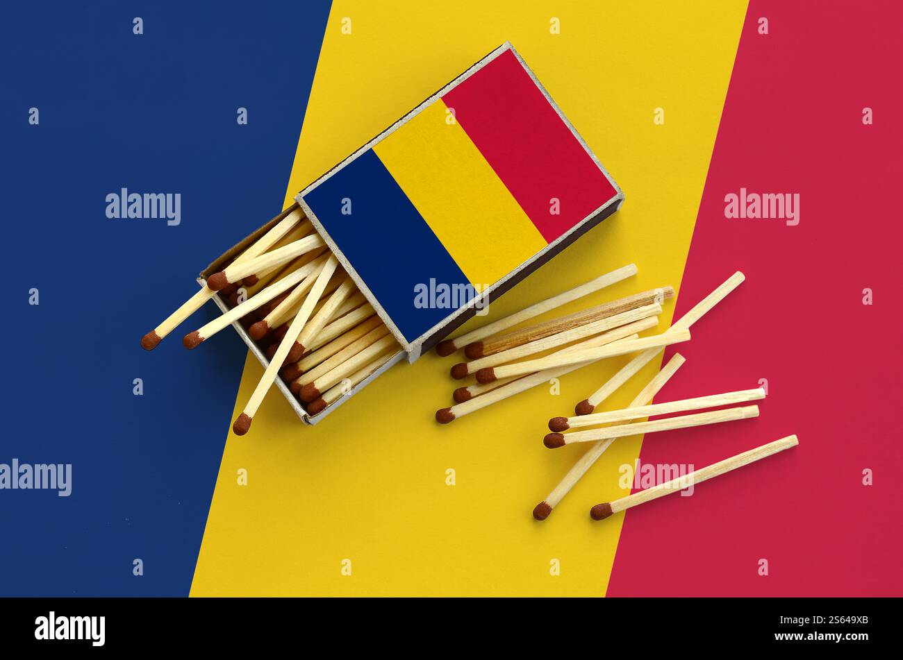 Chad flag is shown on an open matchbox, from which several matches fall ...