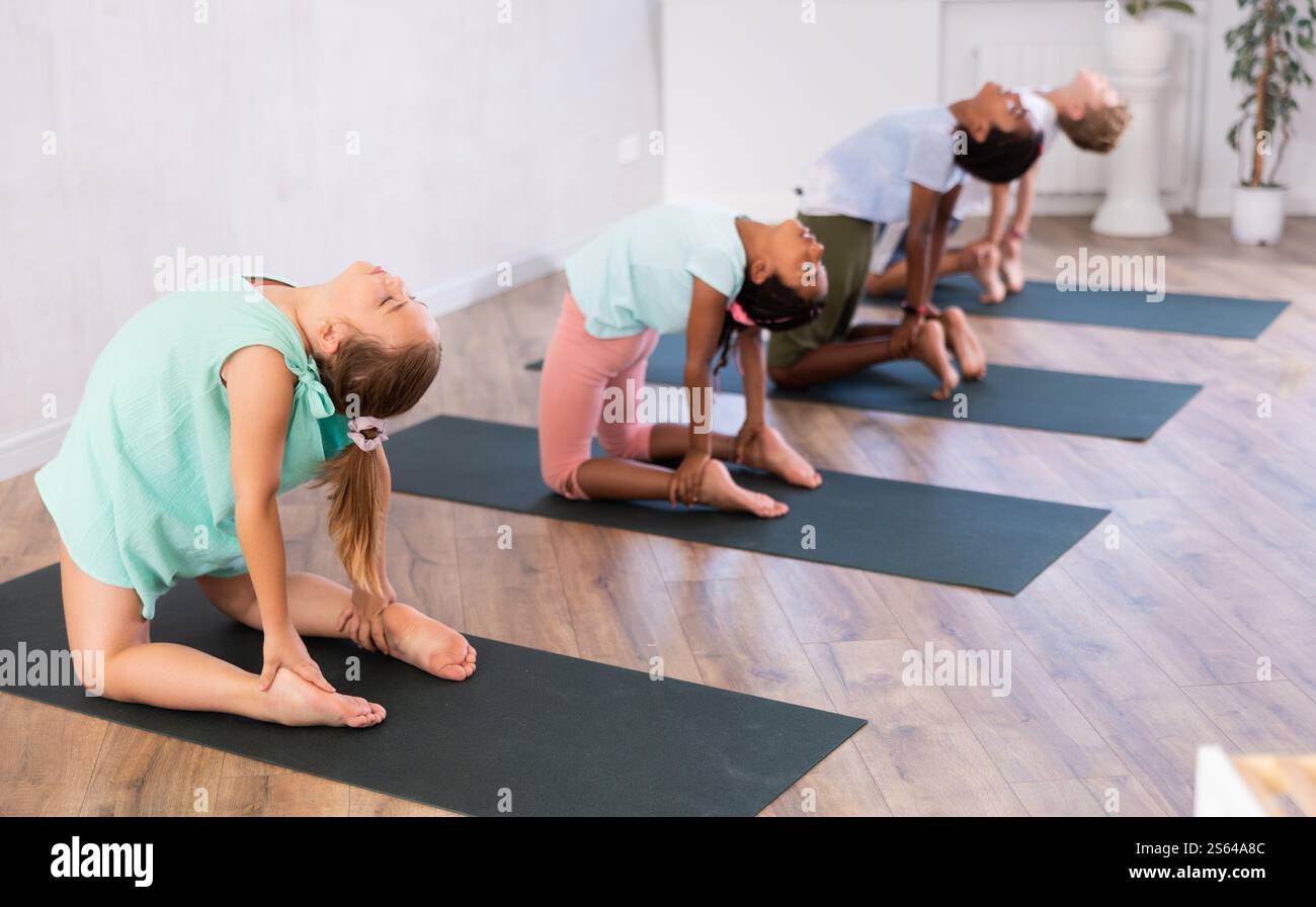 Female teen performs camel pose, Ushtrasana to improve mobility of ...