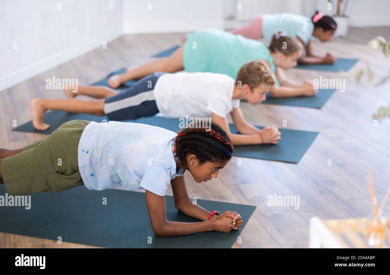 Group of multiethnic children doing pilates in studio Stock Photo - Alamy
