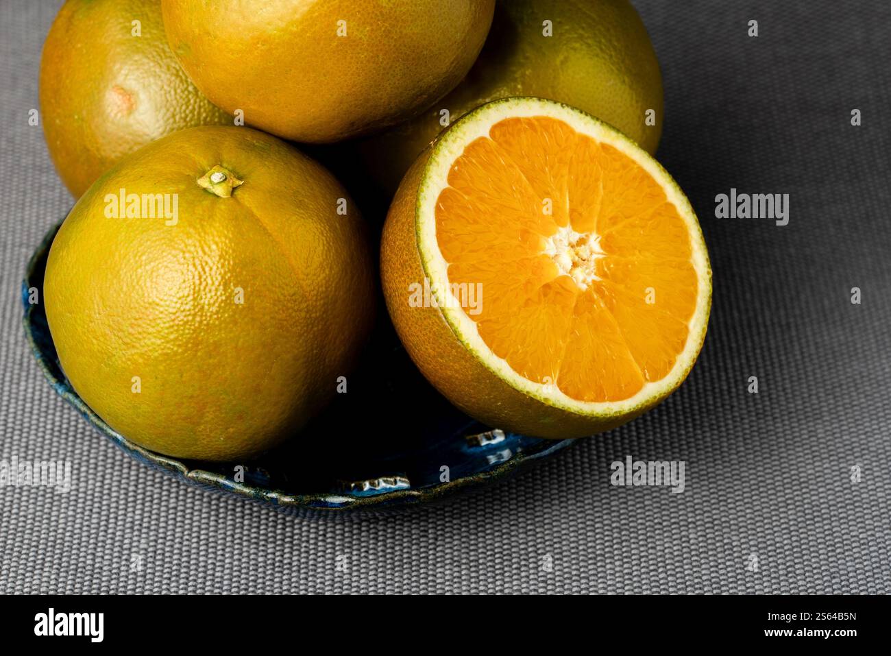 Ripe half of chocolate orange fruit on dark background without shadow ...