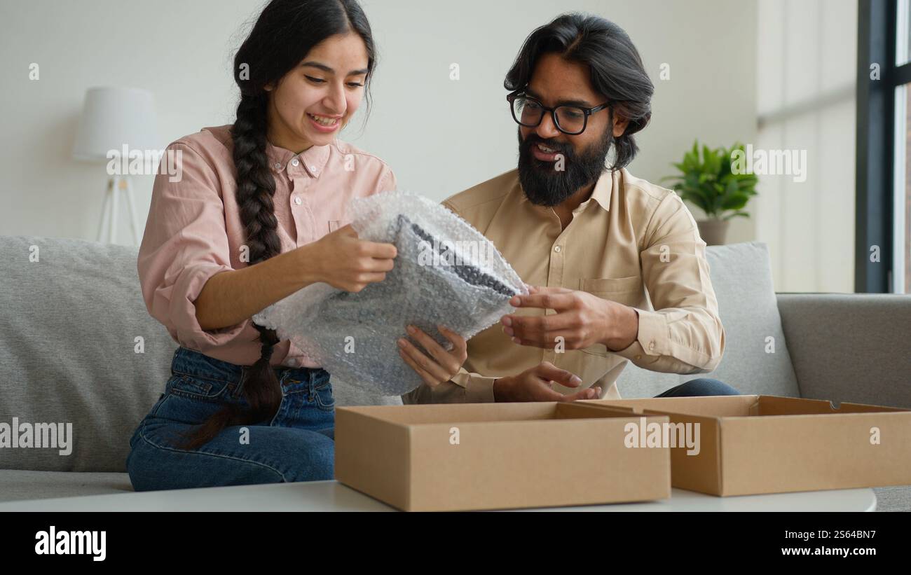 Happy couple customers receive parcel look inside box Arabian Indian ...