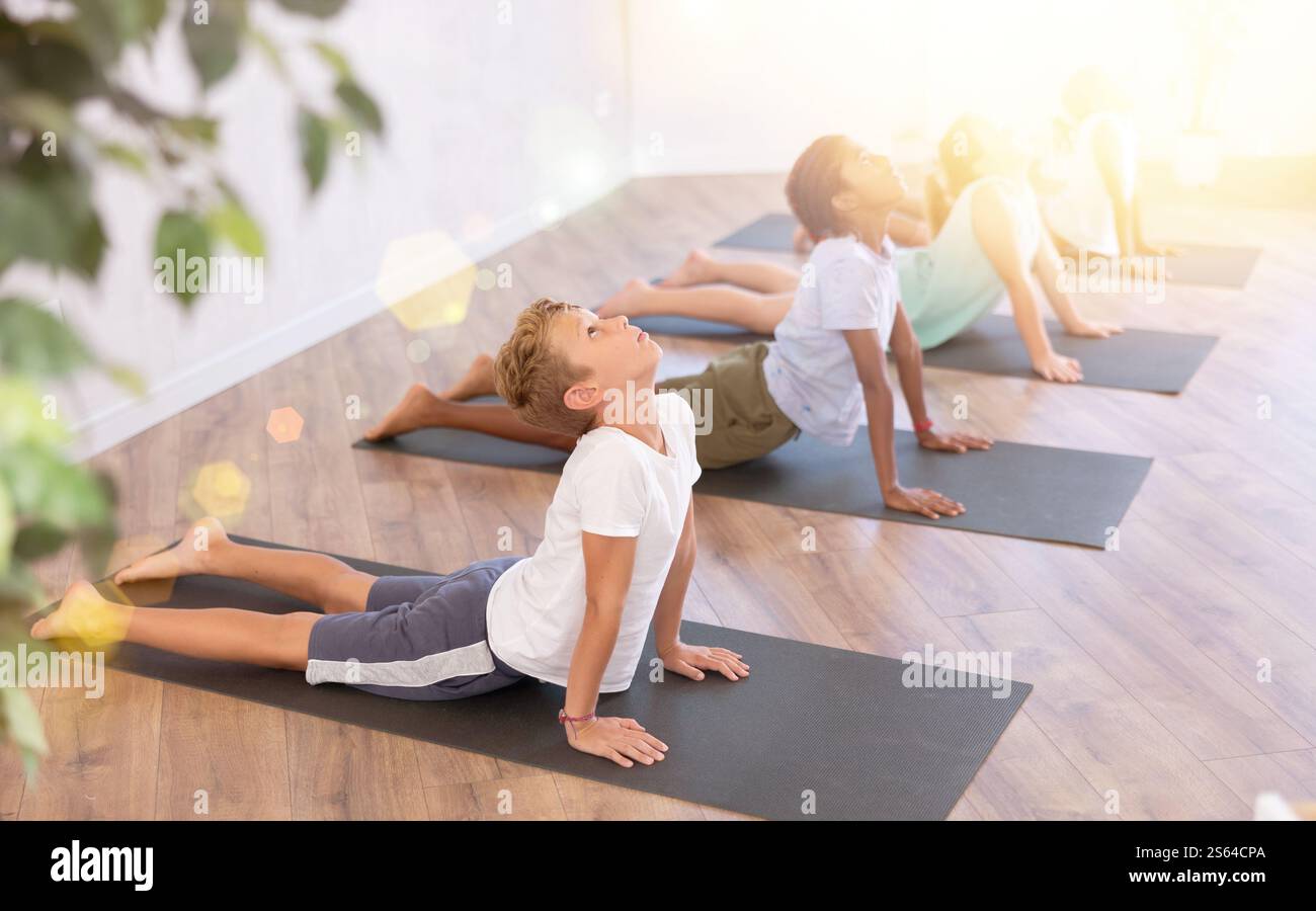 Group of multiethnic children doing yoga in studio Stock Photo - Alamy