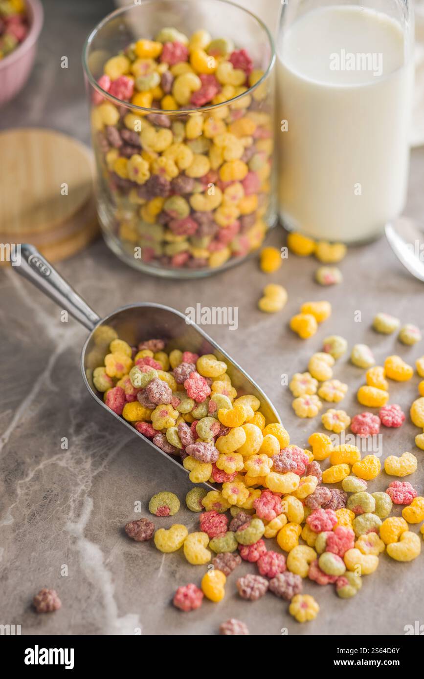 Colorful breakfast cereals in the shape of various fruit on scoop on a ...