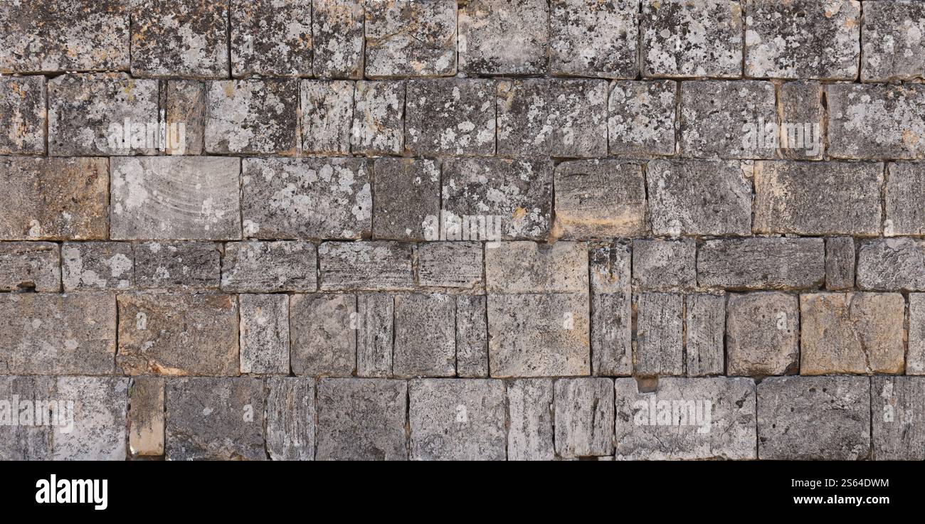 Texture of a stone wall with many big brown and grey stones armed with ...