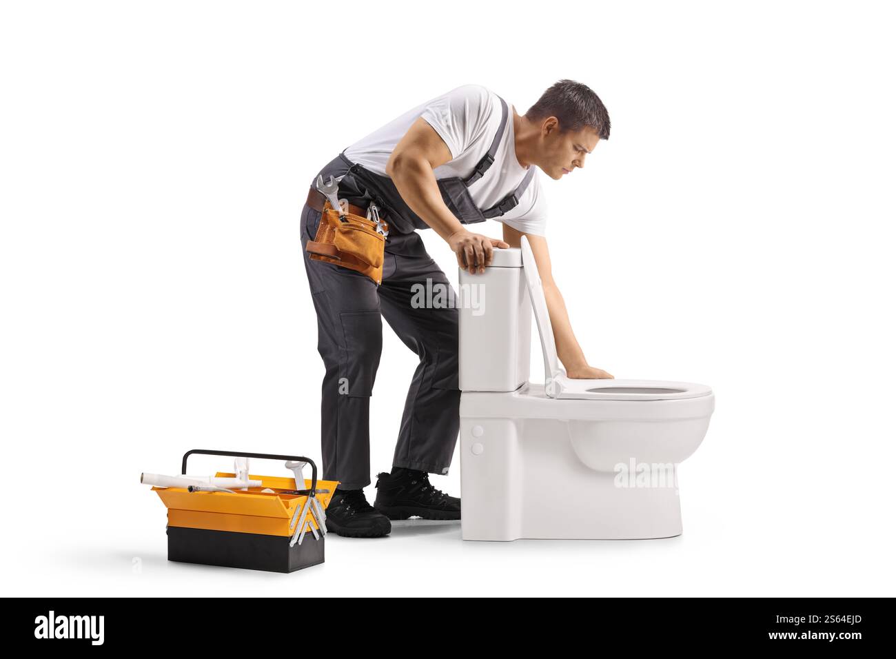 Worker with a tool box installing a toilet seat isolated on white ...