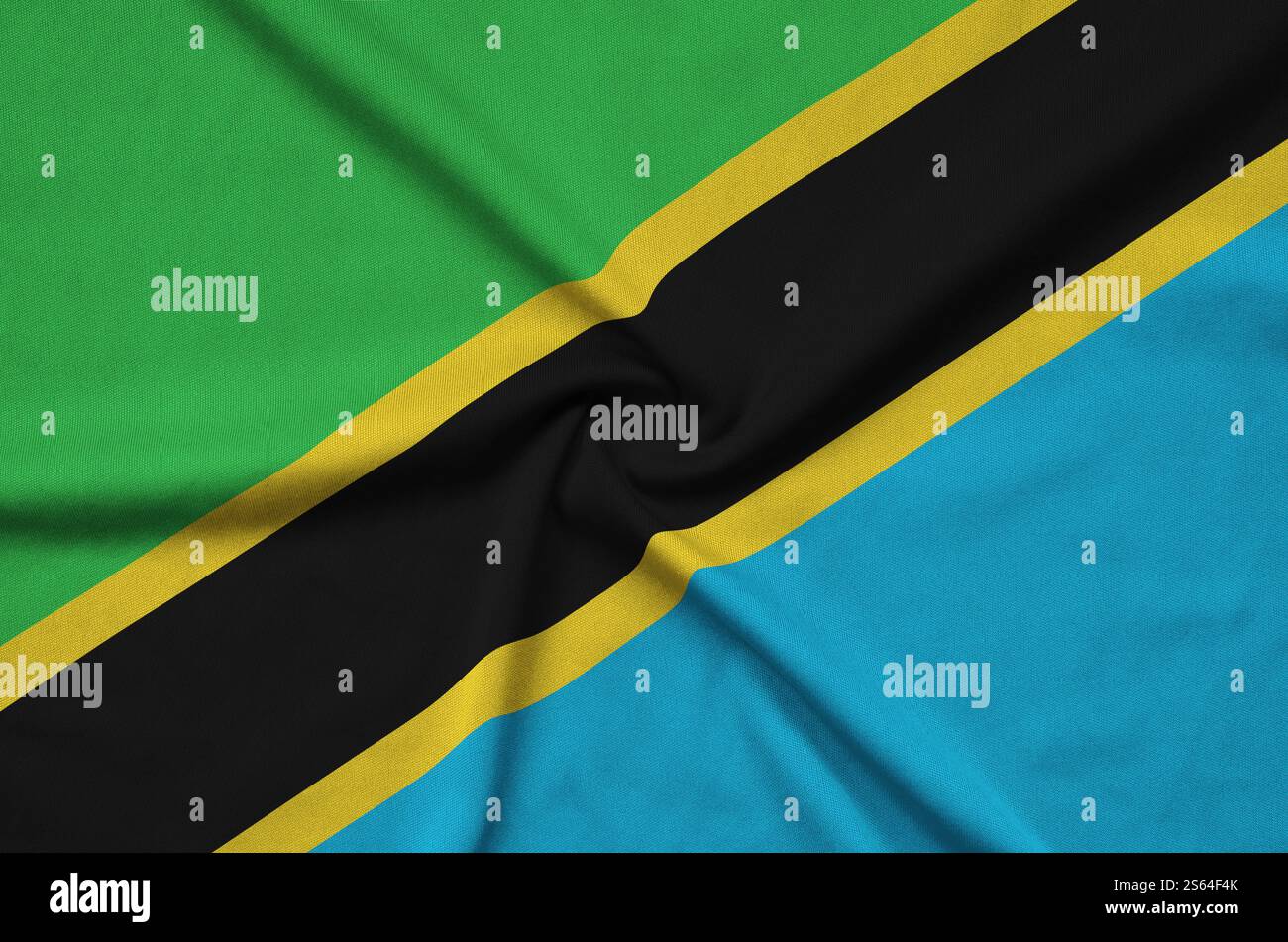 Tanzania flag is depicted on a sports cloth fabric with many folds ...