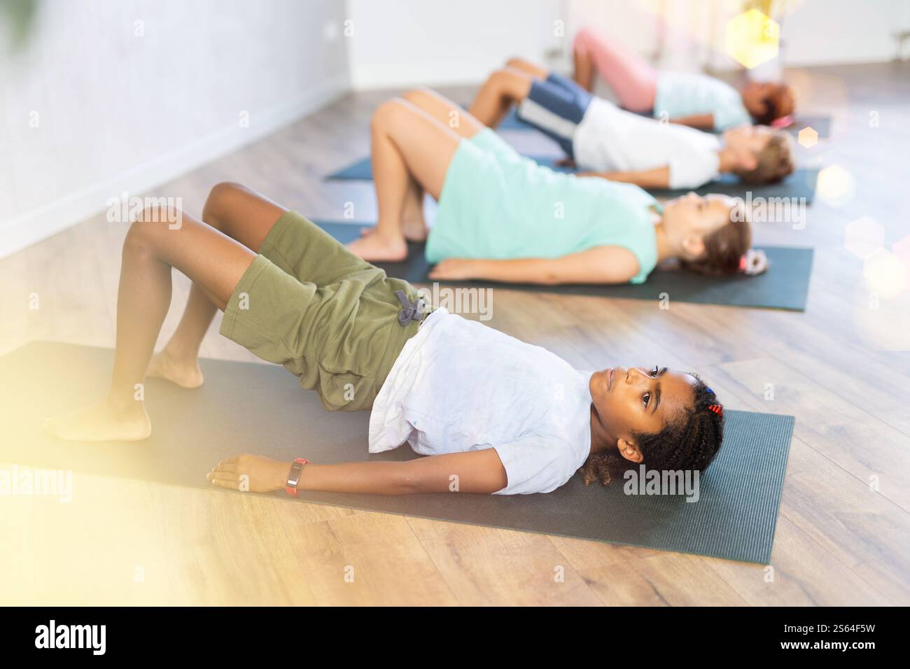 Kids yoga exercise - setu bandha sarvangasana Stock Photo - Alamy